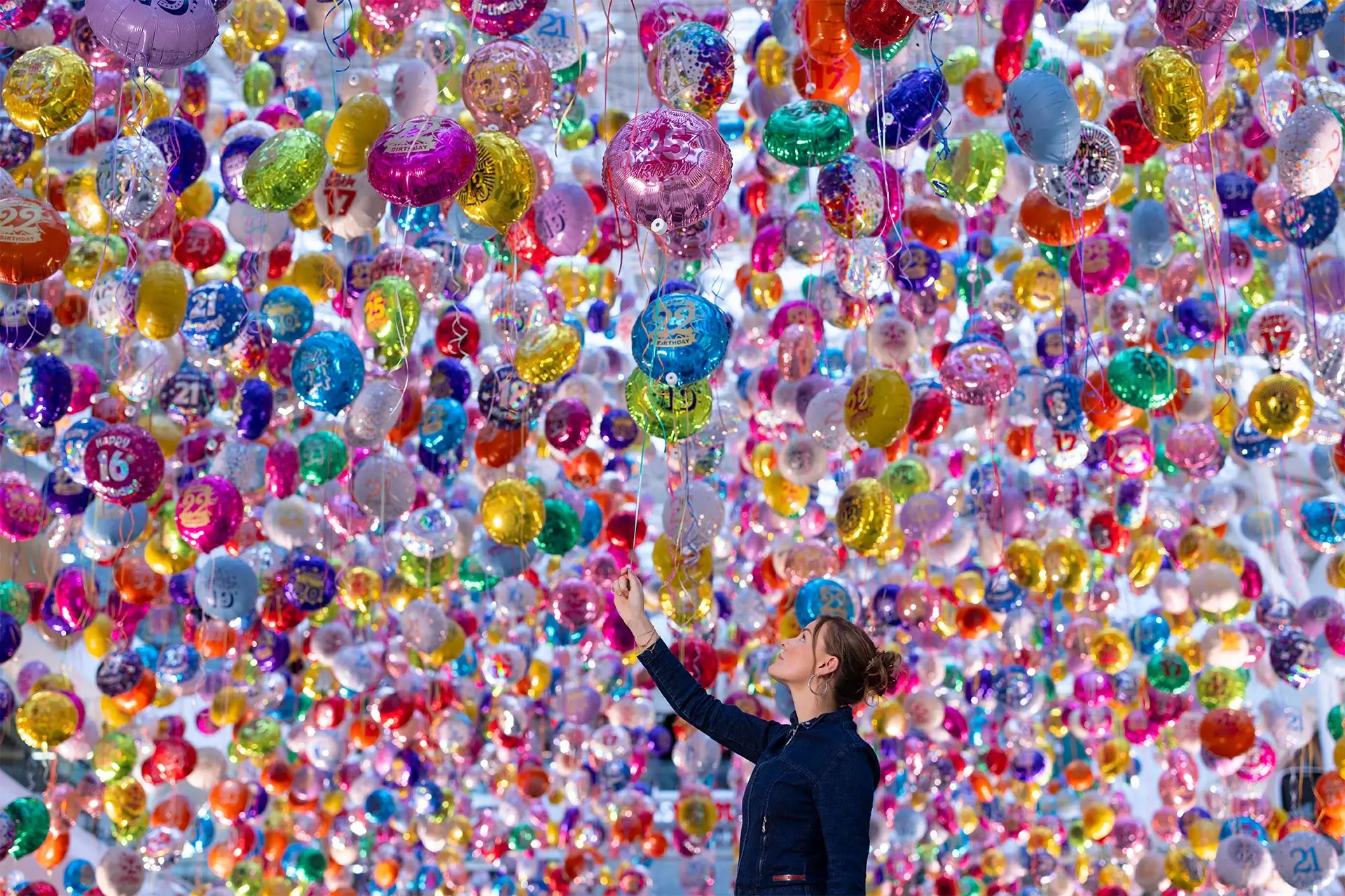 Nearly 7,000 birthday balloons commemorate young people who have taken ...